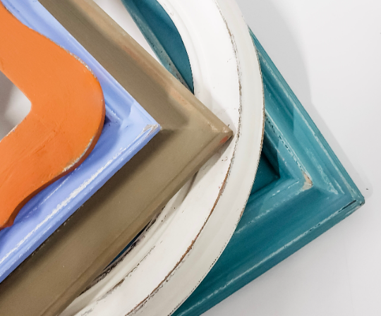 Artful display of mixed picture frames in a modern, rustic color palet ...